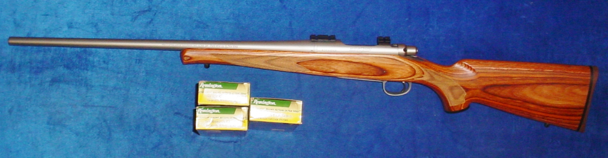 REMINGTON MODEL 7 7MM SAUM STAINLESS LAMINATED BOLT RIFLE WITH 3 BOXES AMMO